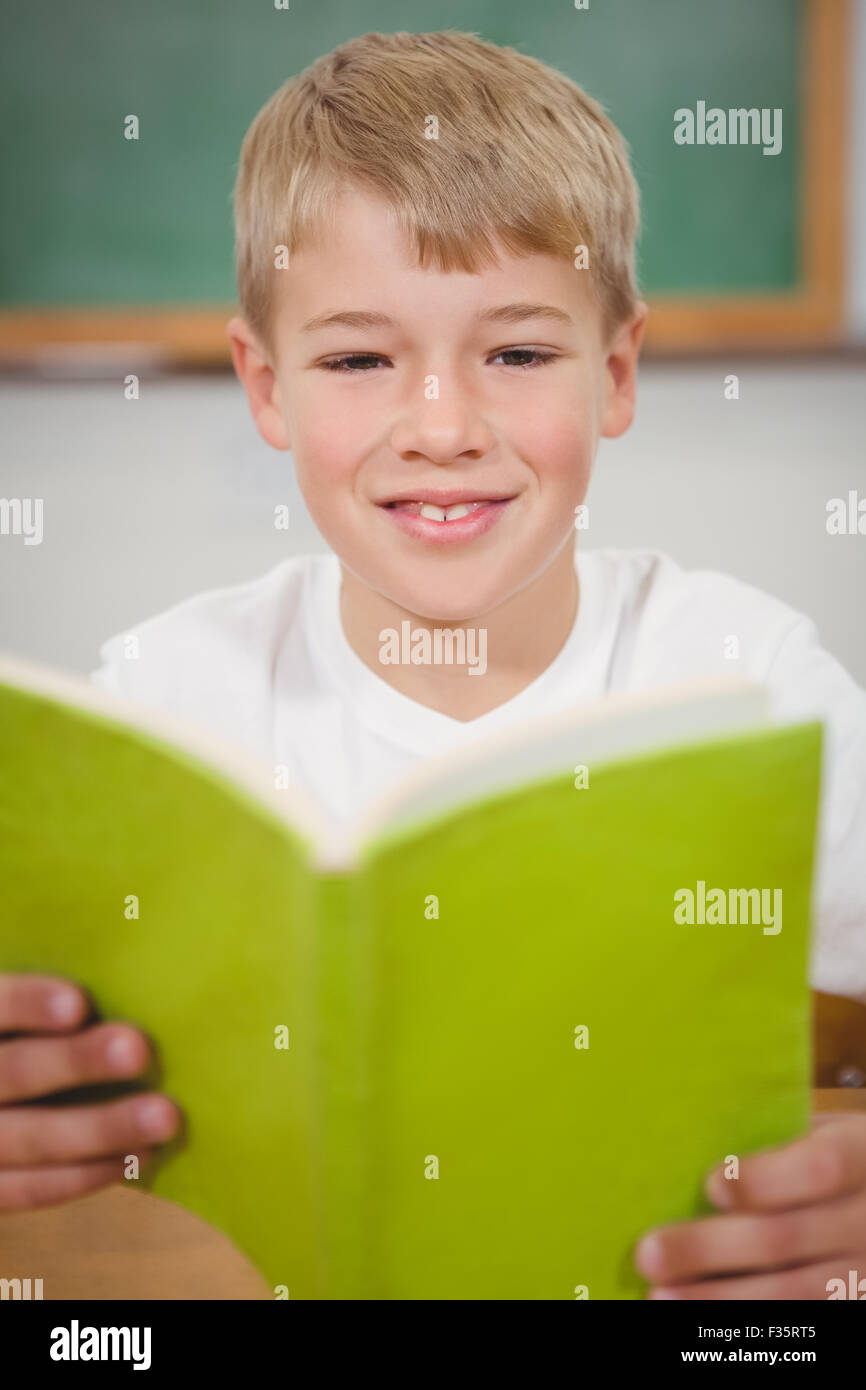 Happy student reading a book Stock Photo - Alamy