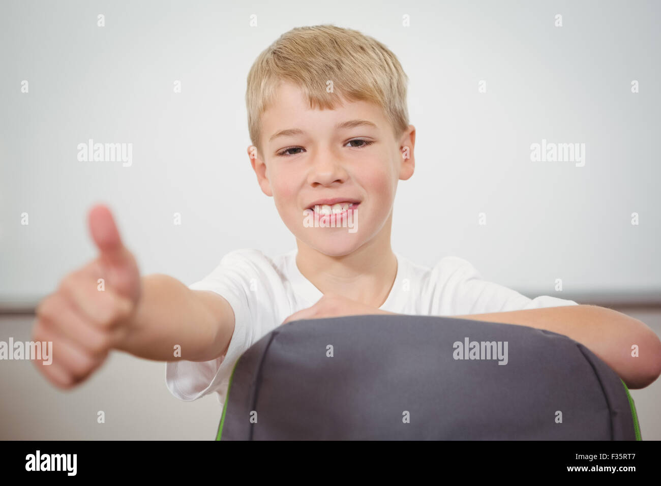 Smiling student giving a thumbs up Stock Photo - Alamy