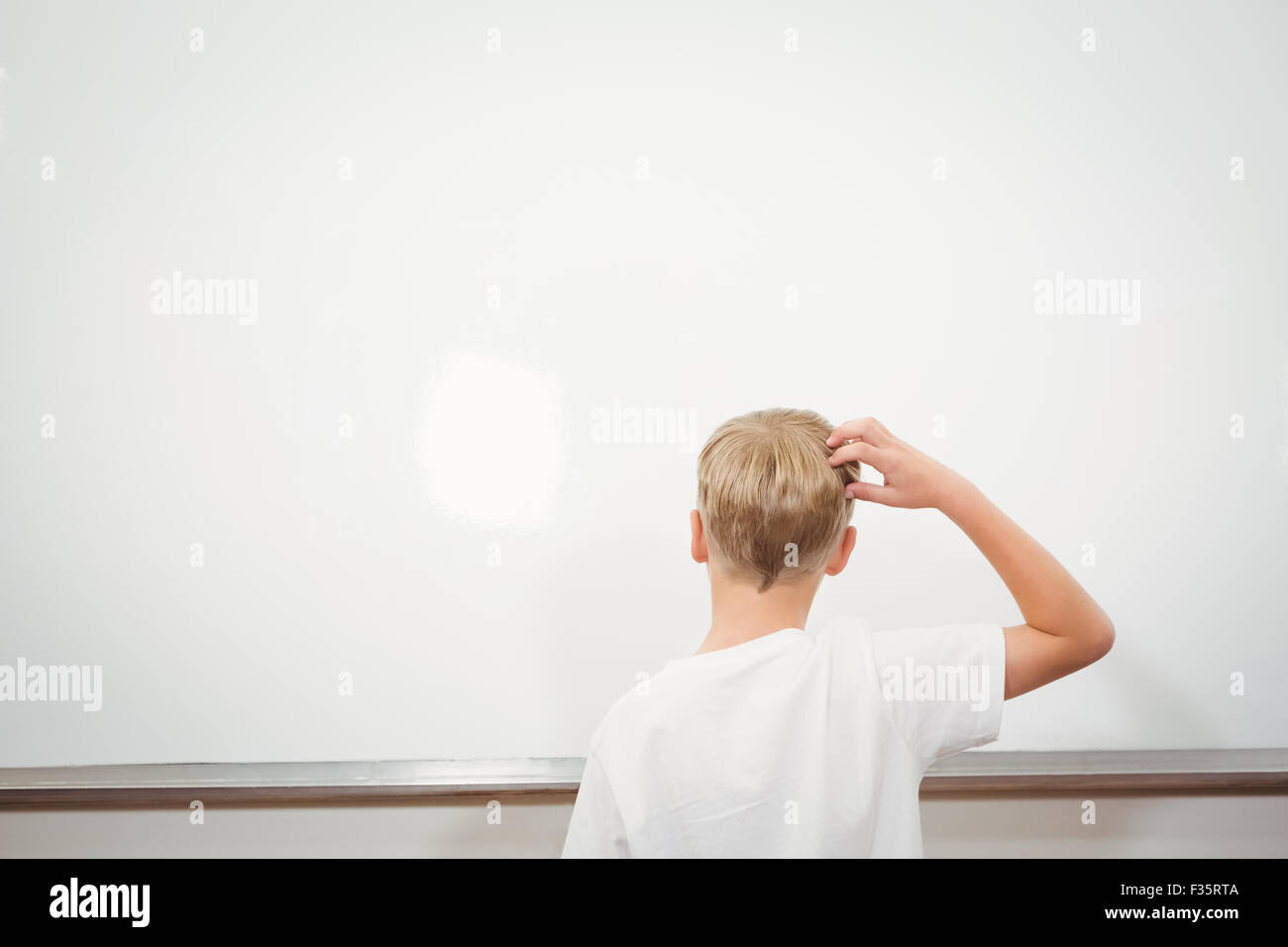 Puzzled student scratching their head Stock Photo - Alamy