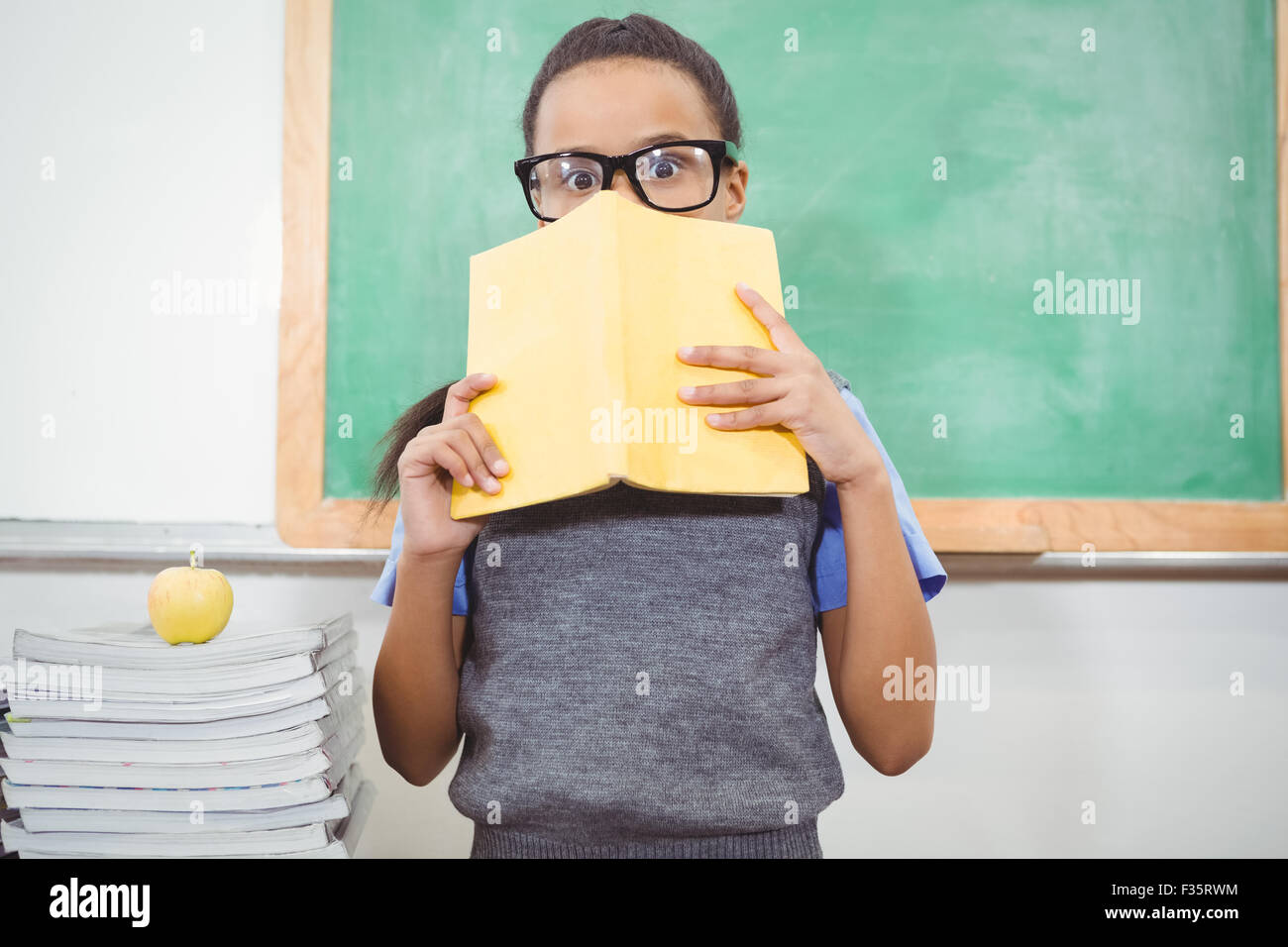 Shocked student holding a book Stock Photo - Alamy