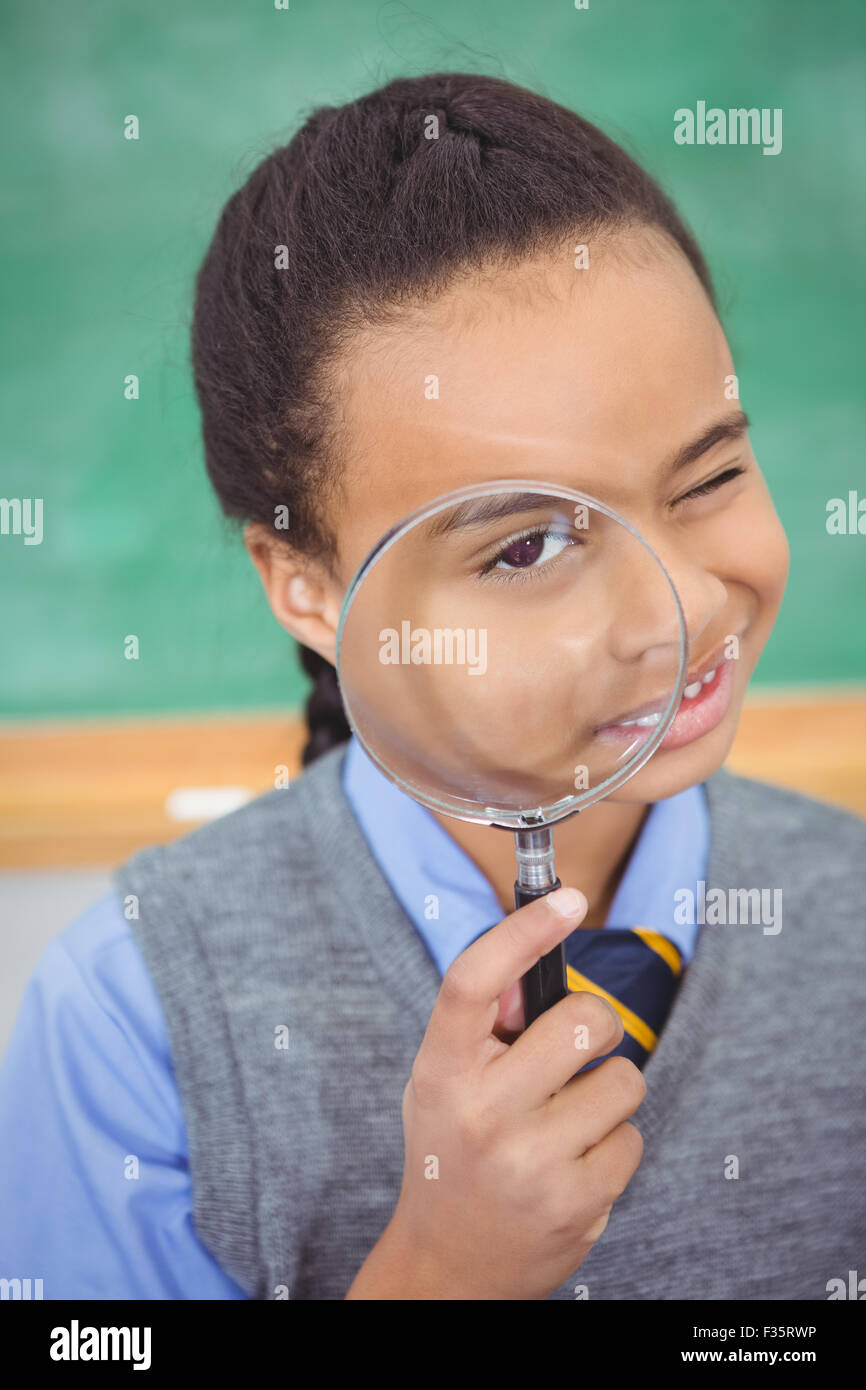 Curious student using a magnifying glass Stock Photo - Alamy