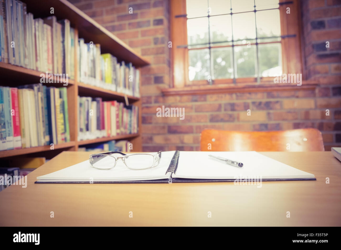 Desk with laptop, glasses and ledger on it Stock Photo - Alamy