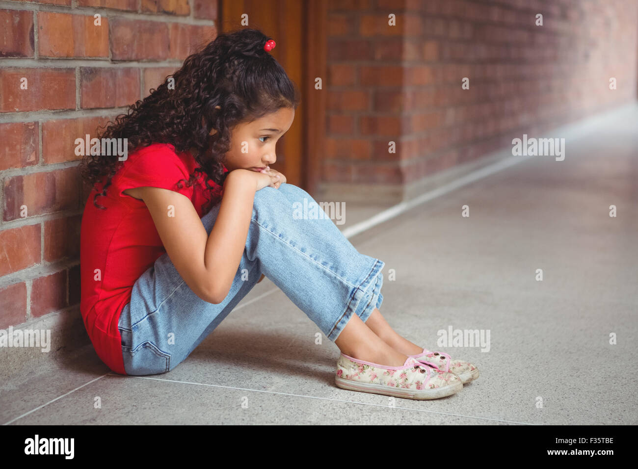 Upset lonely girl sitting by herself Stock Photo - Alamy