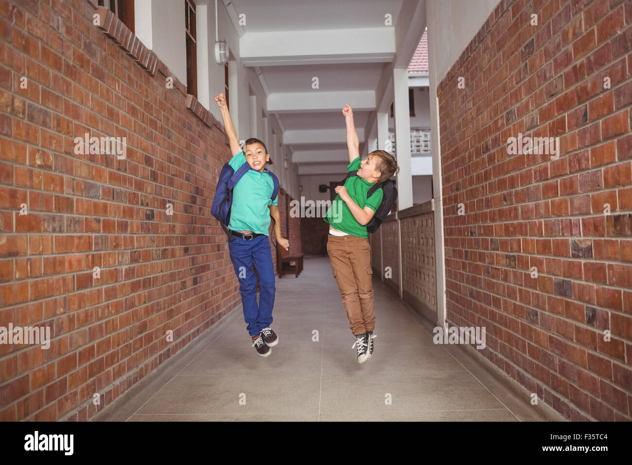 Students running and jumping down the hall Stock Photo - Alamy