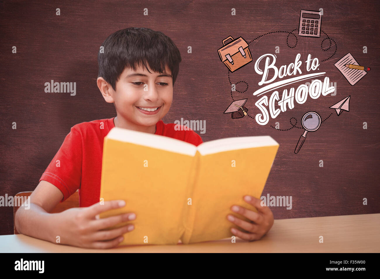 Composite image of cute boy reading book in library Stock Photo - Alamy