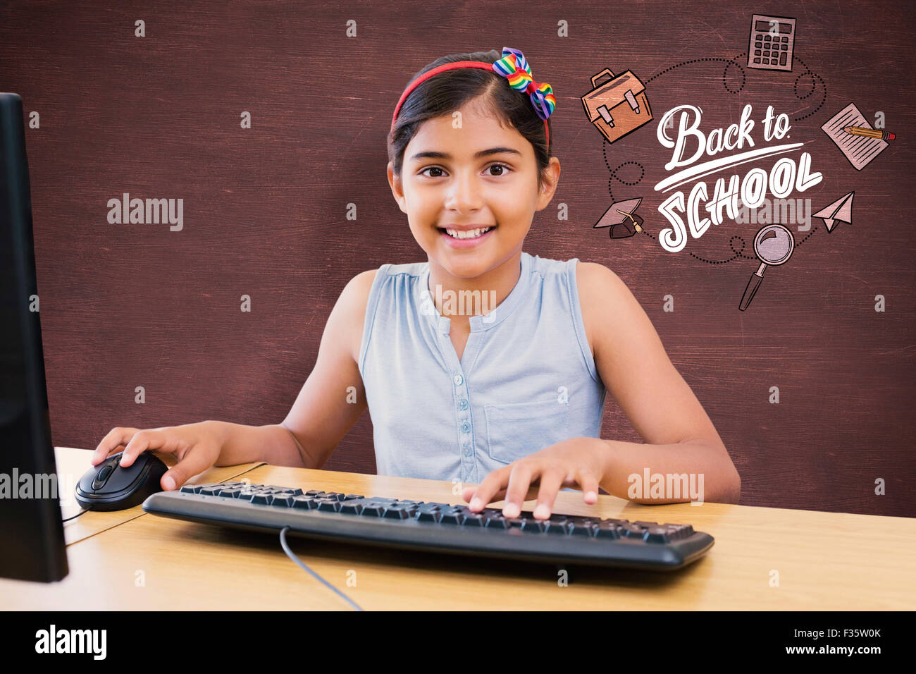Composite image of school kid on computer Stock Photo - Alamy
