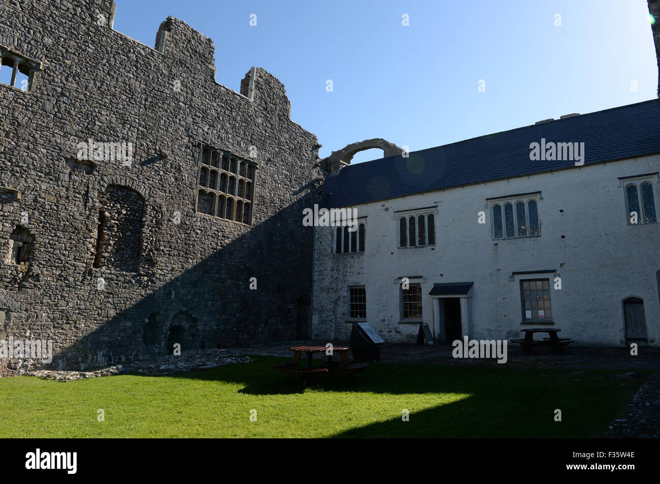 Oxwich castle with its fortified walls extensive windows and Tudor ...