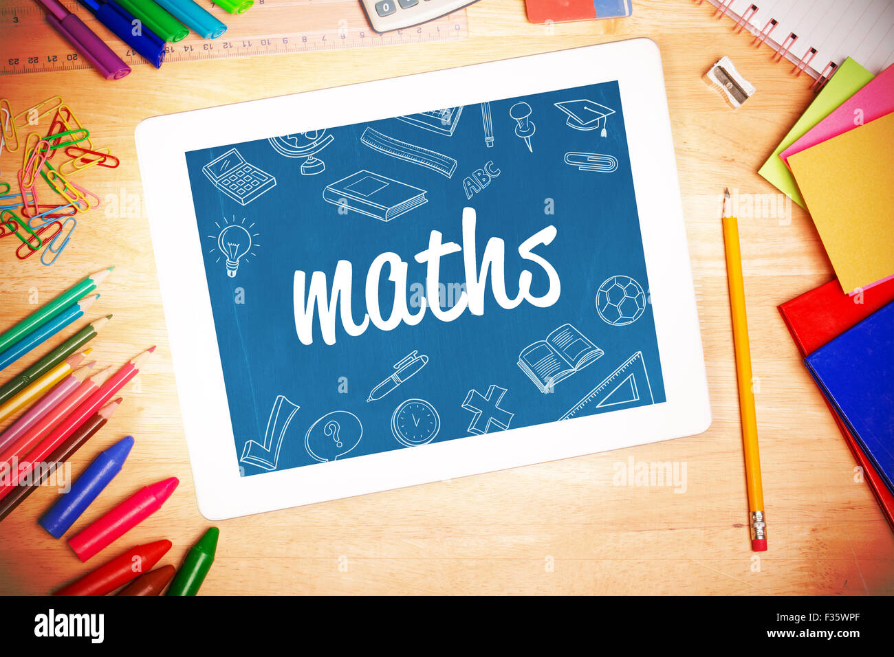 Maths against students desk with tablet pc Stock Photo - Alamy
