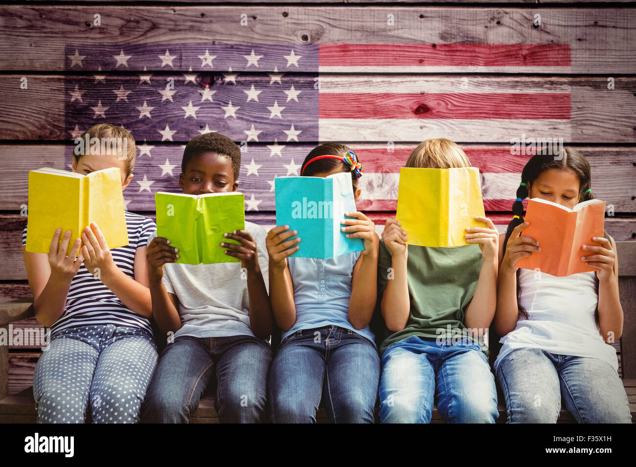 Composite image of children reading books at park Stock Photo - Alamy