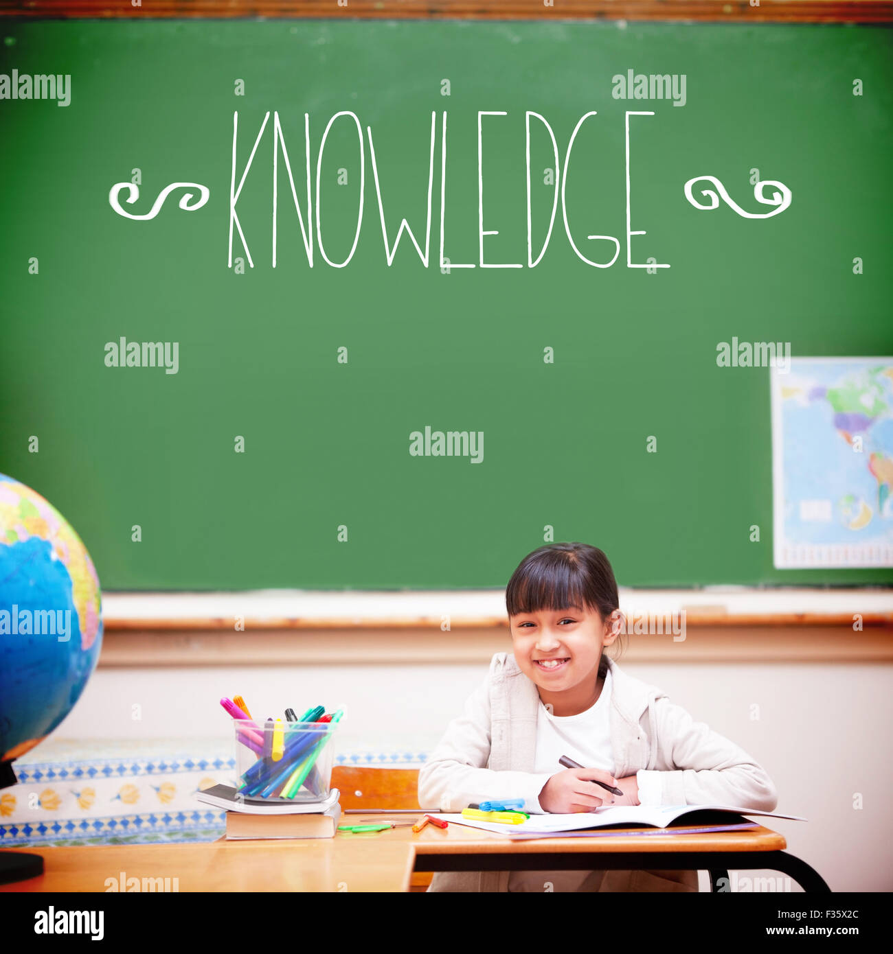Knowledge against cute pupil sitting at desk Stock Photo - Alamy