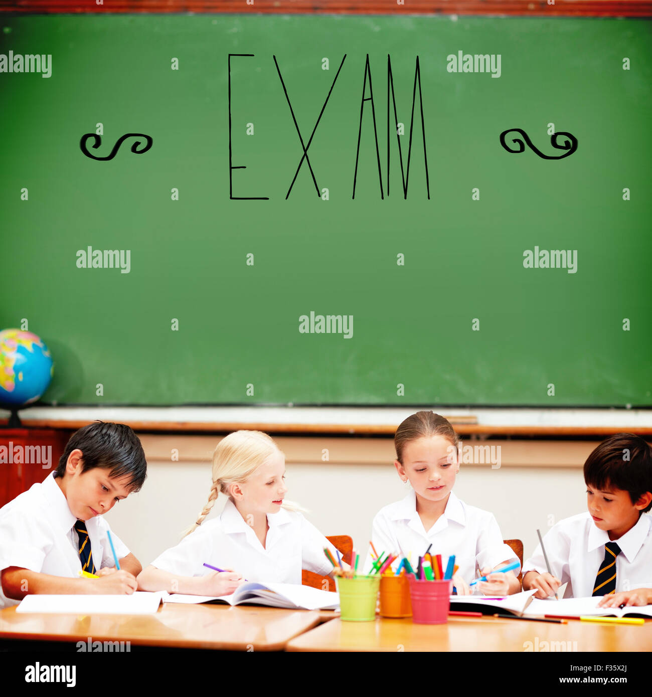 Exam against cute pupils sitting at desk Stock Photo - Alamy