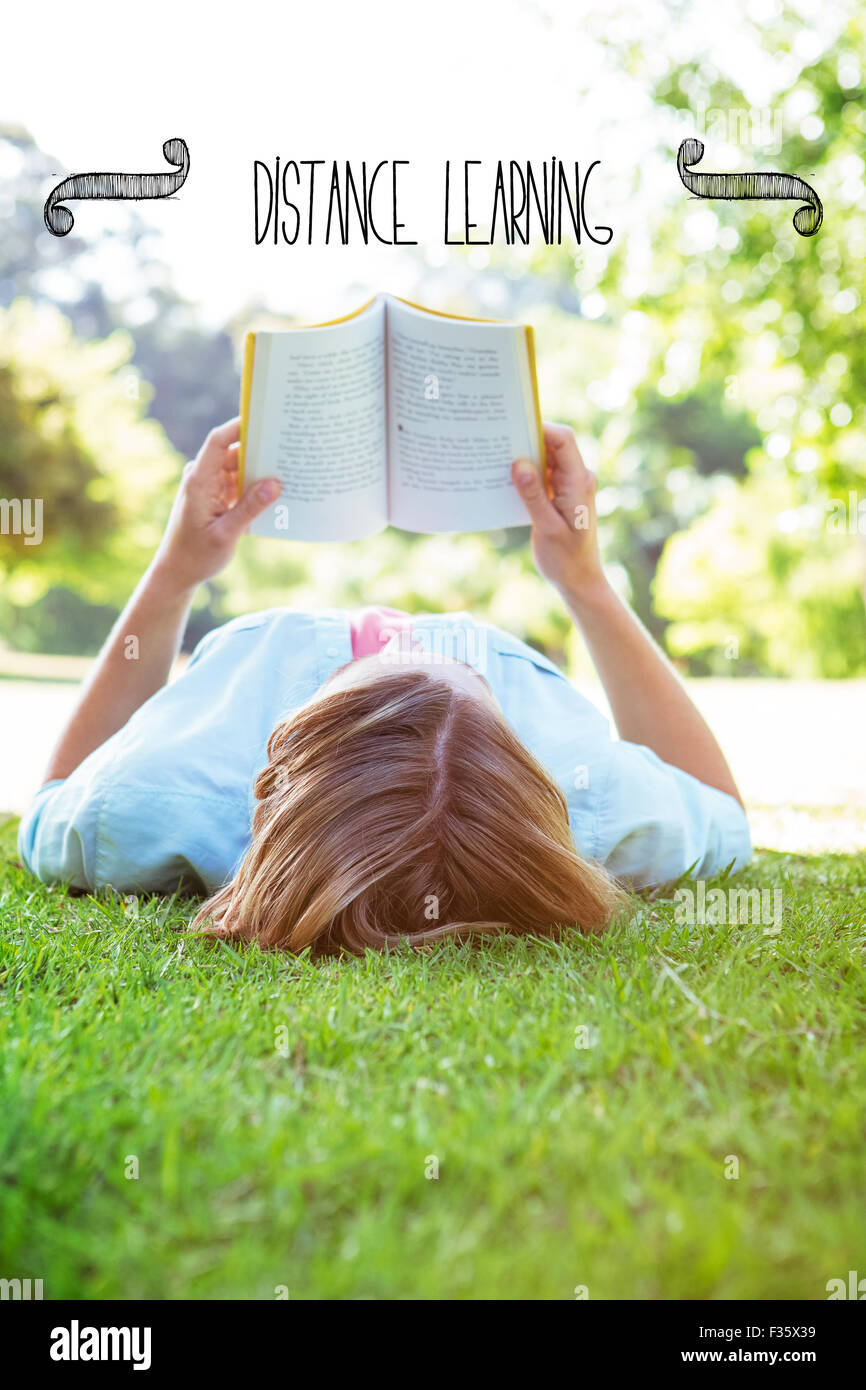 Distance learning against pretty woman reading book in park Stock Photo ...