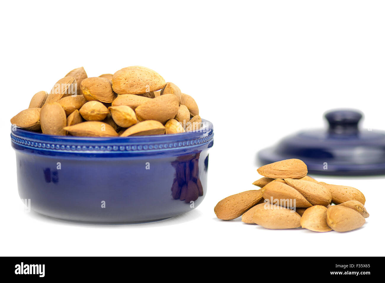 Organic shelled almonds, selective view of almonds using a deep blue ...
