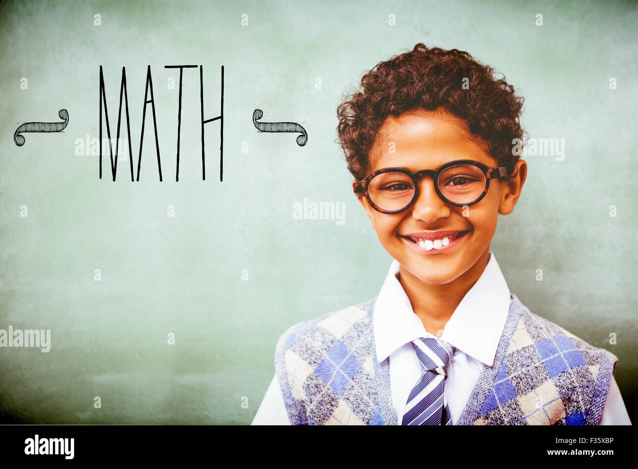 Math against cute little boy smiling in classroom Stock Photo - Alamy