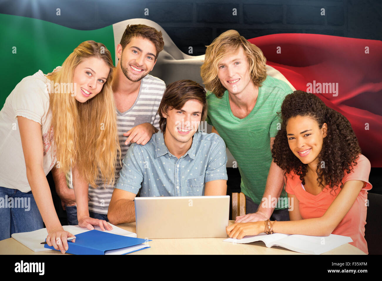 Composite image of college students using laptop in library Stock Photo ...