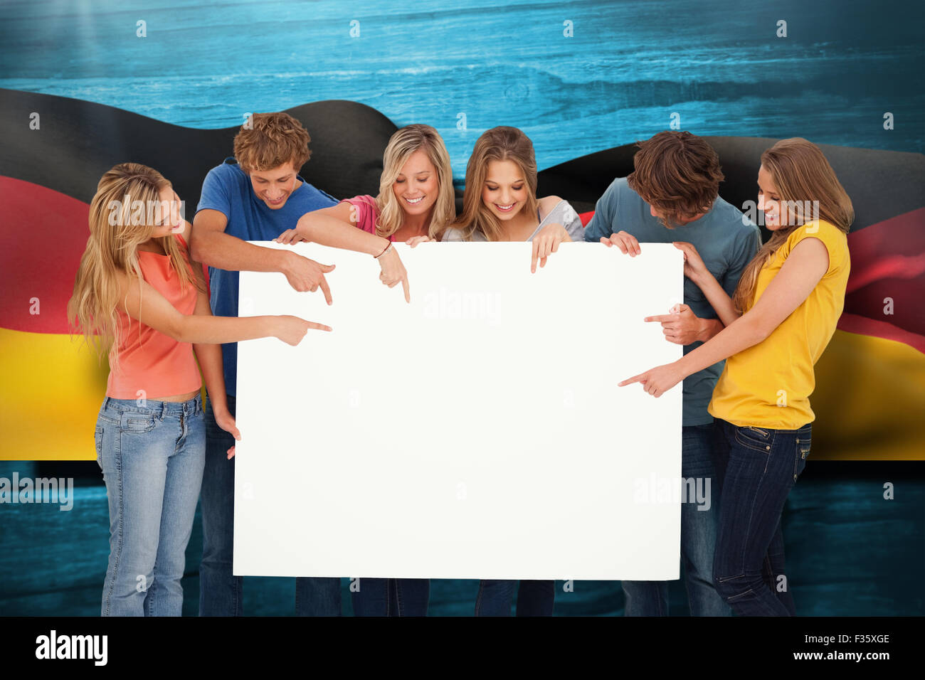 Composite image of a group holding a blank sheet and pointing to it ...