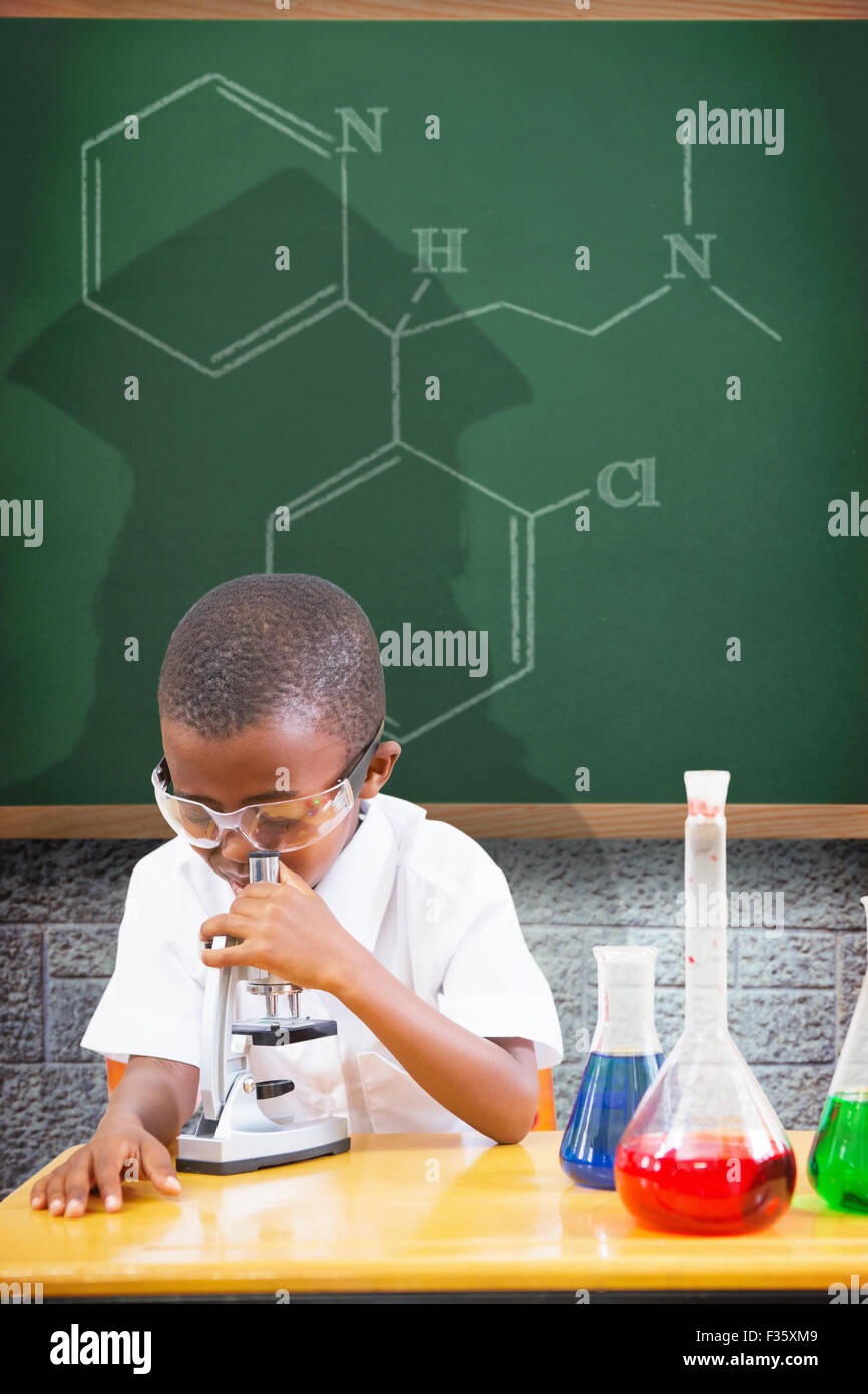 Composite image of cute pupil playing scientist Stock Photo - Alamy