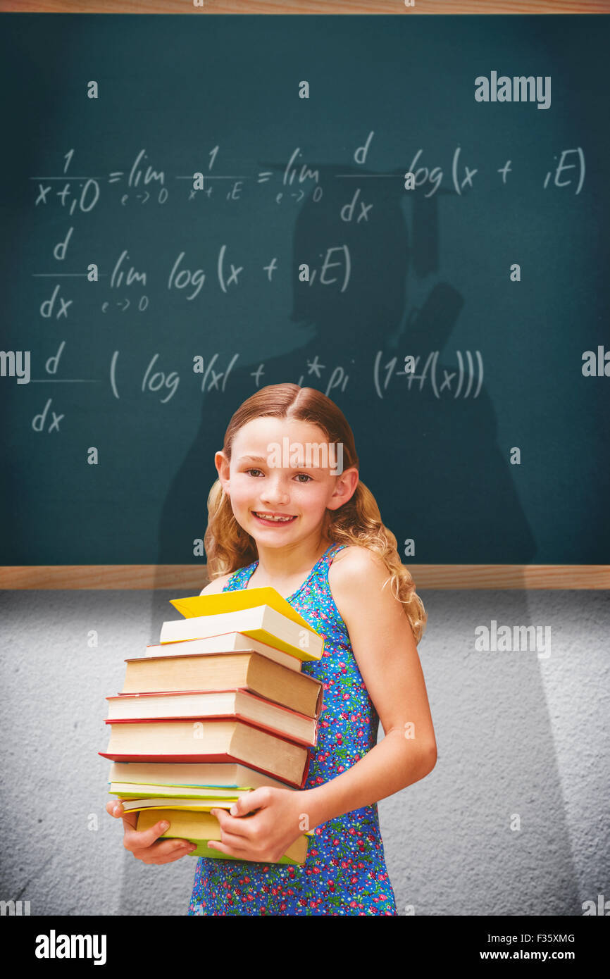 Composite image of cute little girl carrying books in library Stock ...