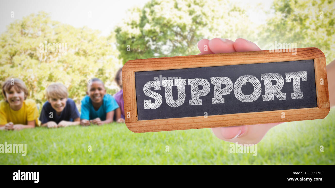Support against happy friends in the park Stock Photo - Alamy
