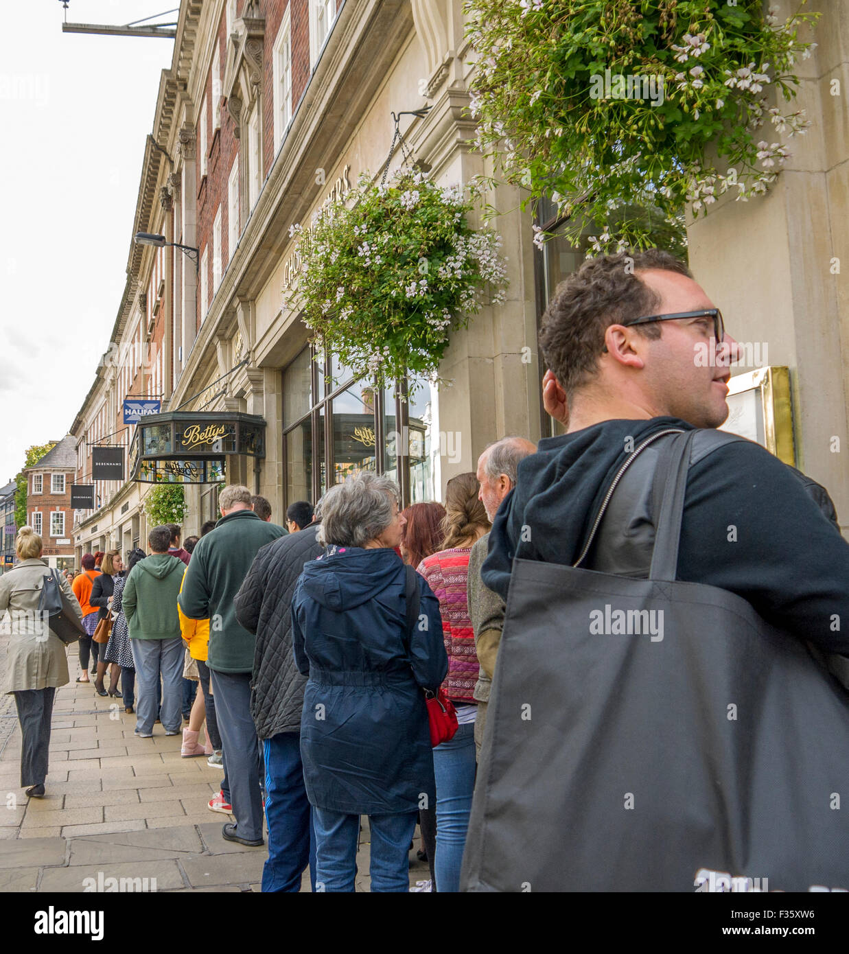 People queuing outside Bettys team rooms in York Stock Photo - Alamy