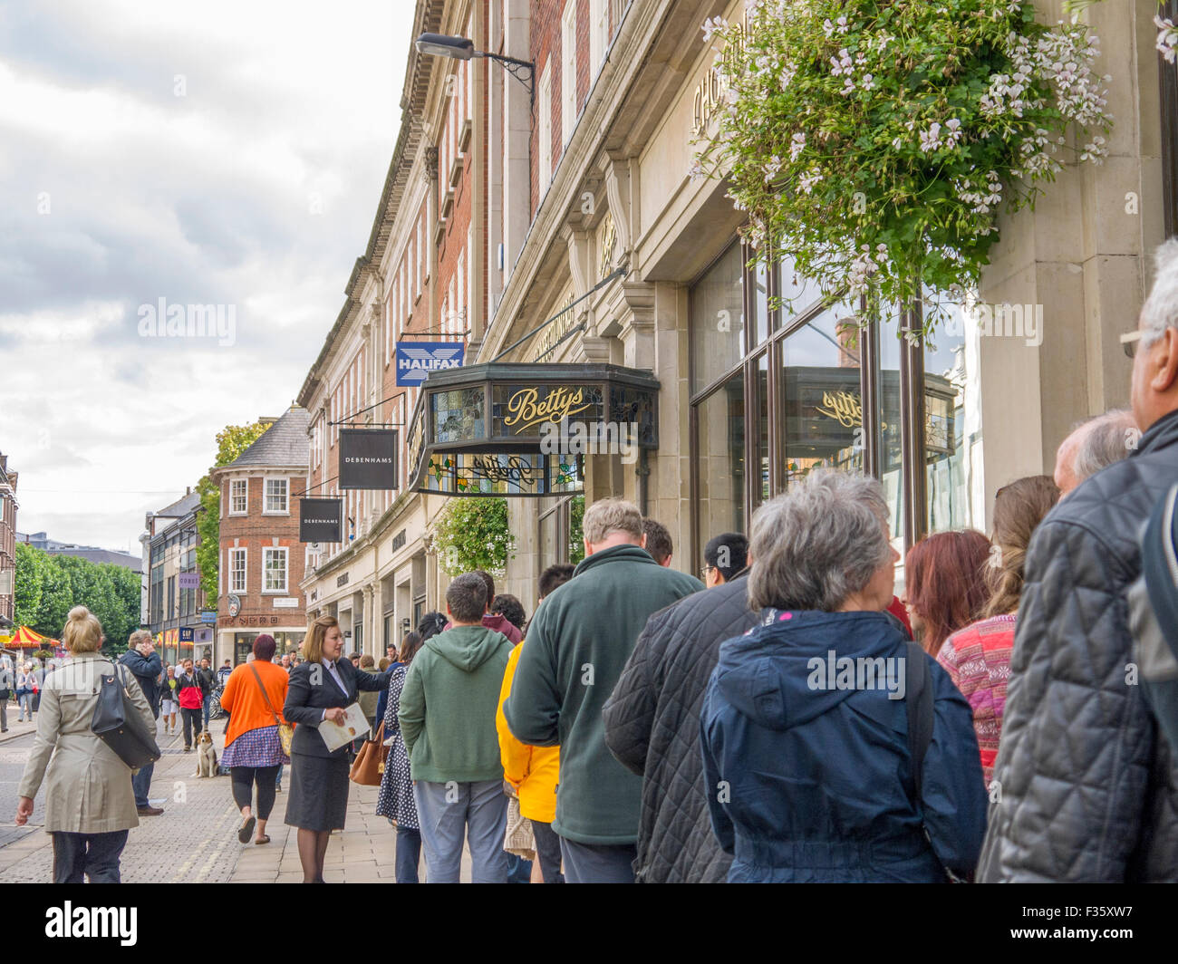People queuing outside Bettys team rooms in York Stock Photo - Alamy