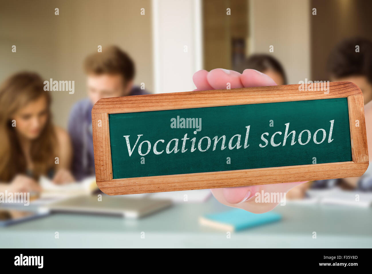 Vocational school against smiling friends students revising together ...