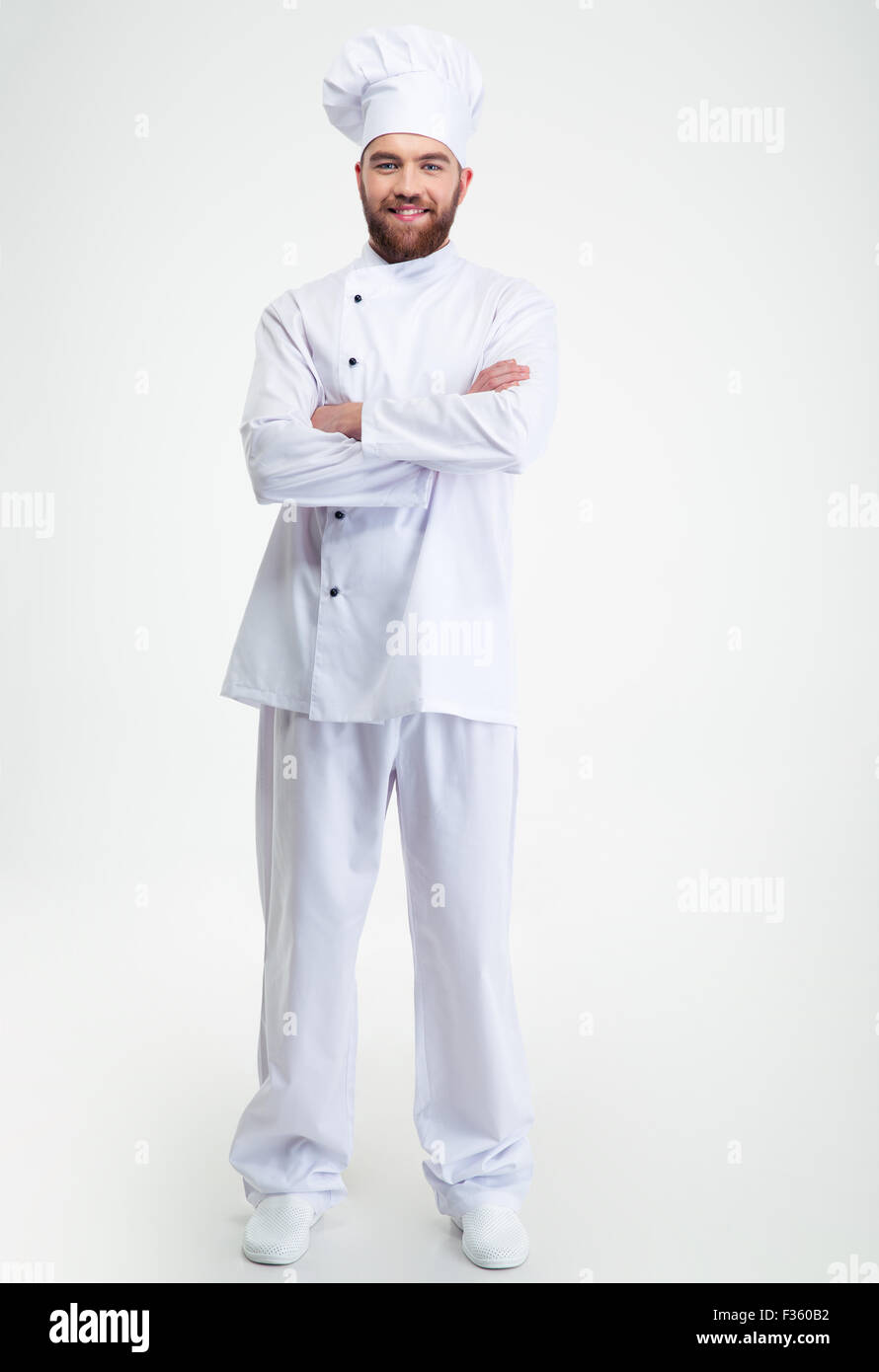 Full length portrait of a smiling male chef cook standing with arms ...