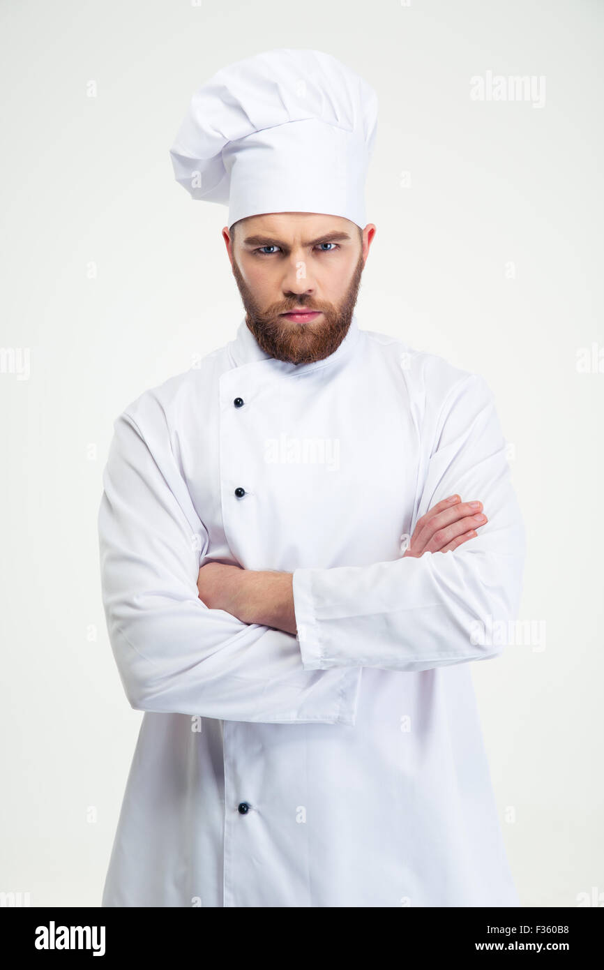 Portrait of angry male chef cook standing with arms folded isolated on ...
