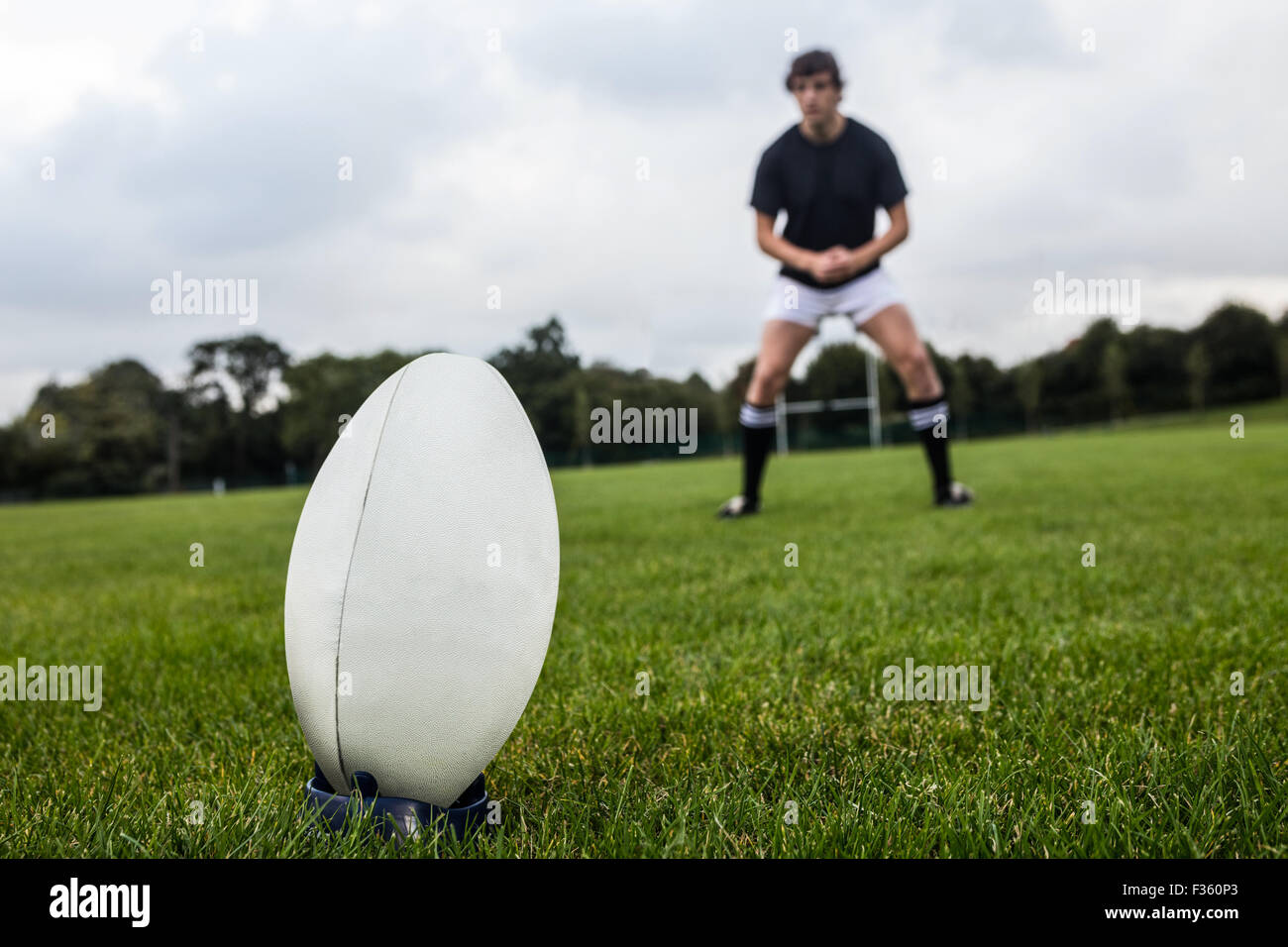 Rugby player about to kick ball Stock Photo - Alamy