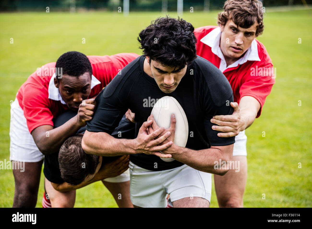 Rugby players tackling during game Stock Photo - Alamy