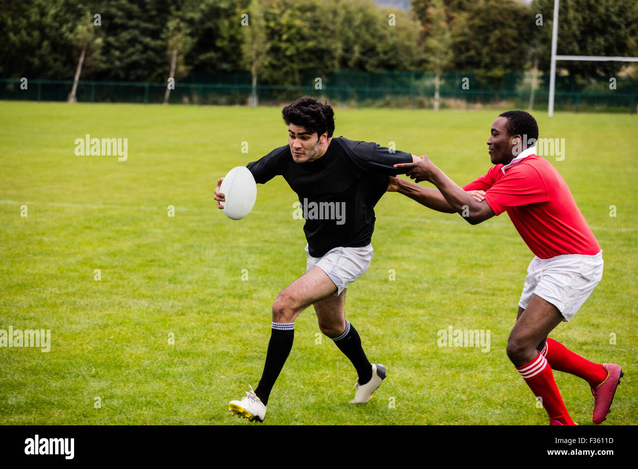 Rugby players tackling during game Stock Photo - Alamy