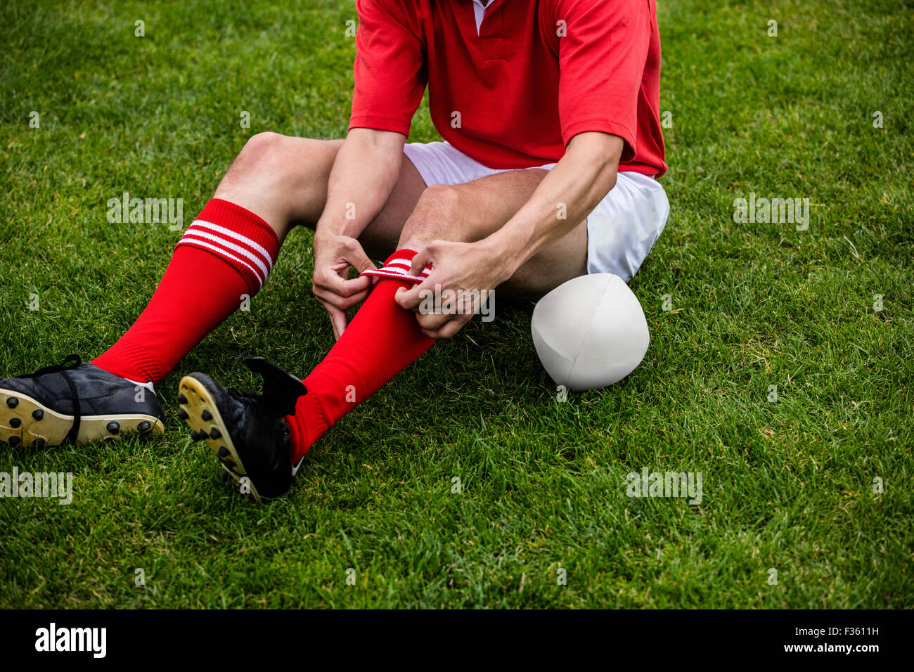 Rugby player sitting on grass Stock Photo - Alamy