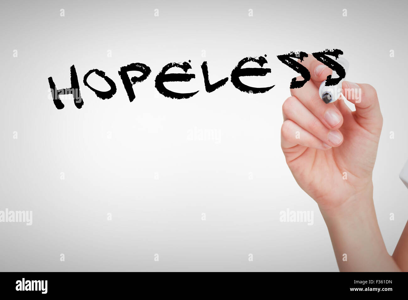 Hopeless against female hand holding whiteboard marker Stock Photo - Alamy