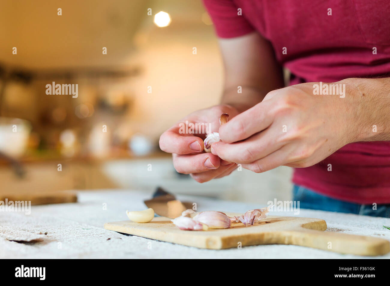 Man peeling garlic Stock Photo - Alamy
