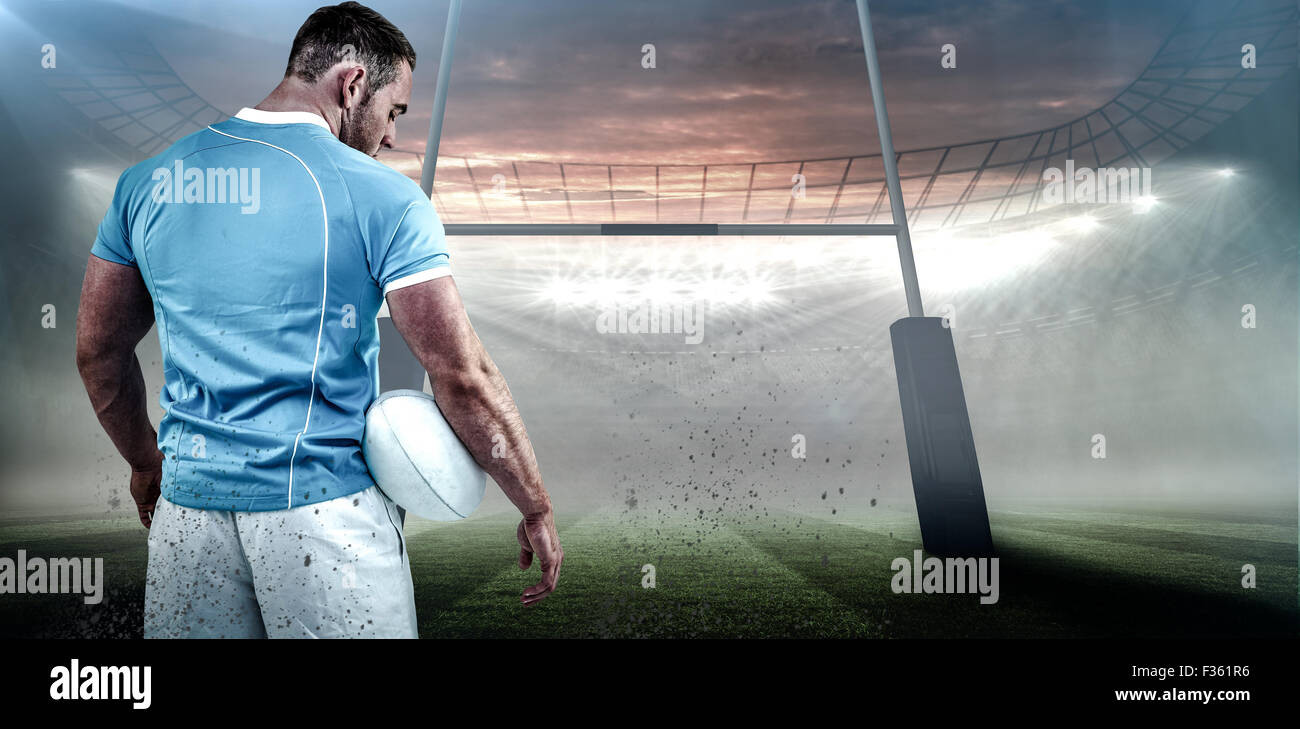 Composite image of rugby player standing with ball Stock Photo - Alamy