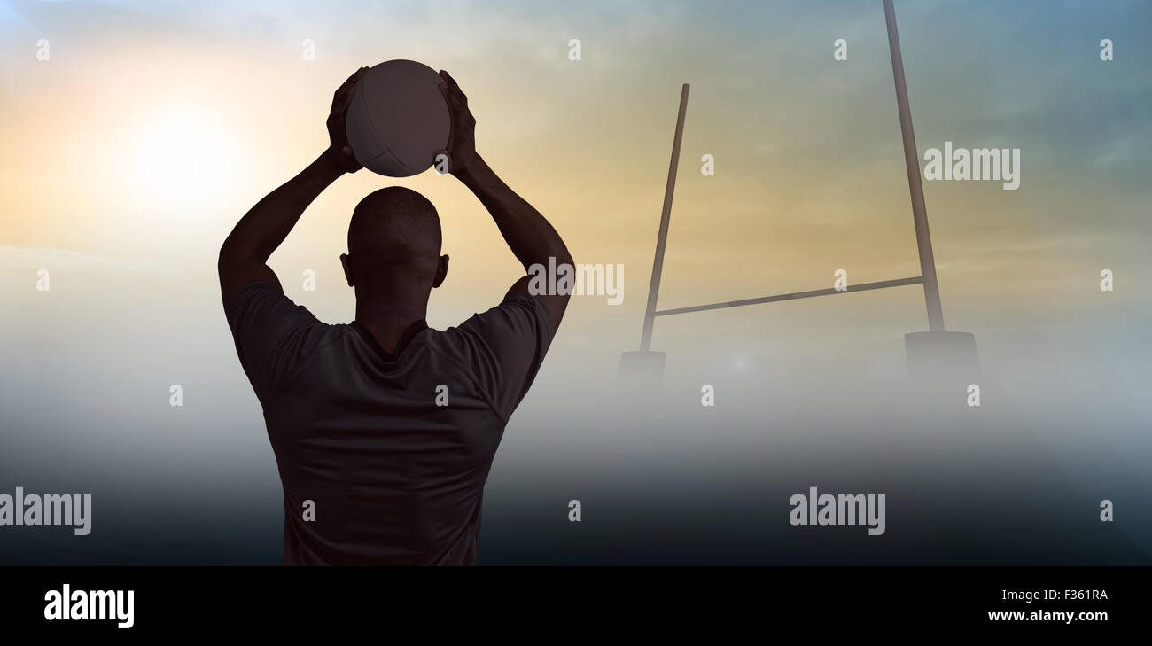 Composite image of rear view of athlete throwing rugby ball Stock Photo ...