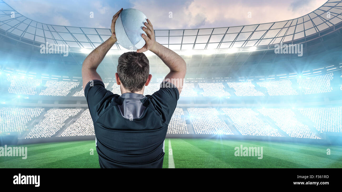 Composite image of back turned rugby player throwing a ball Stock Photo ...