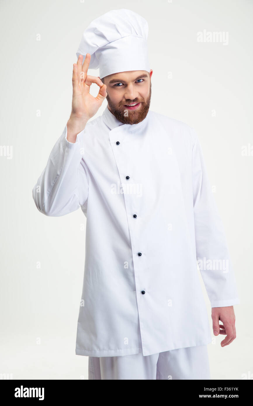 Portrait of a male chef cook showing ok sign isolated on a white ...