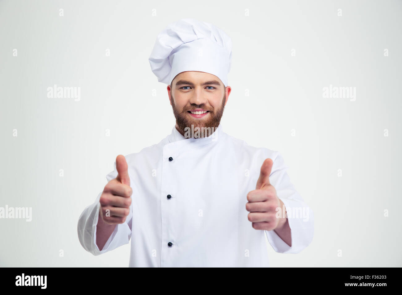 Portrait of a happy male chef cook showing thumbs up isolated on a ...