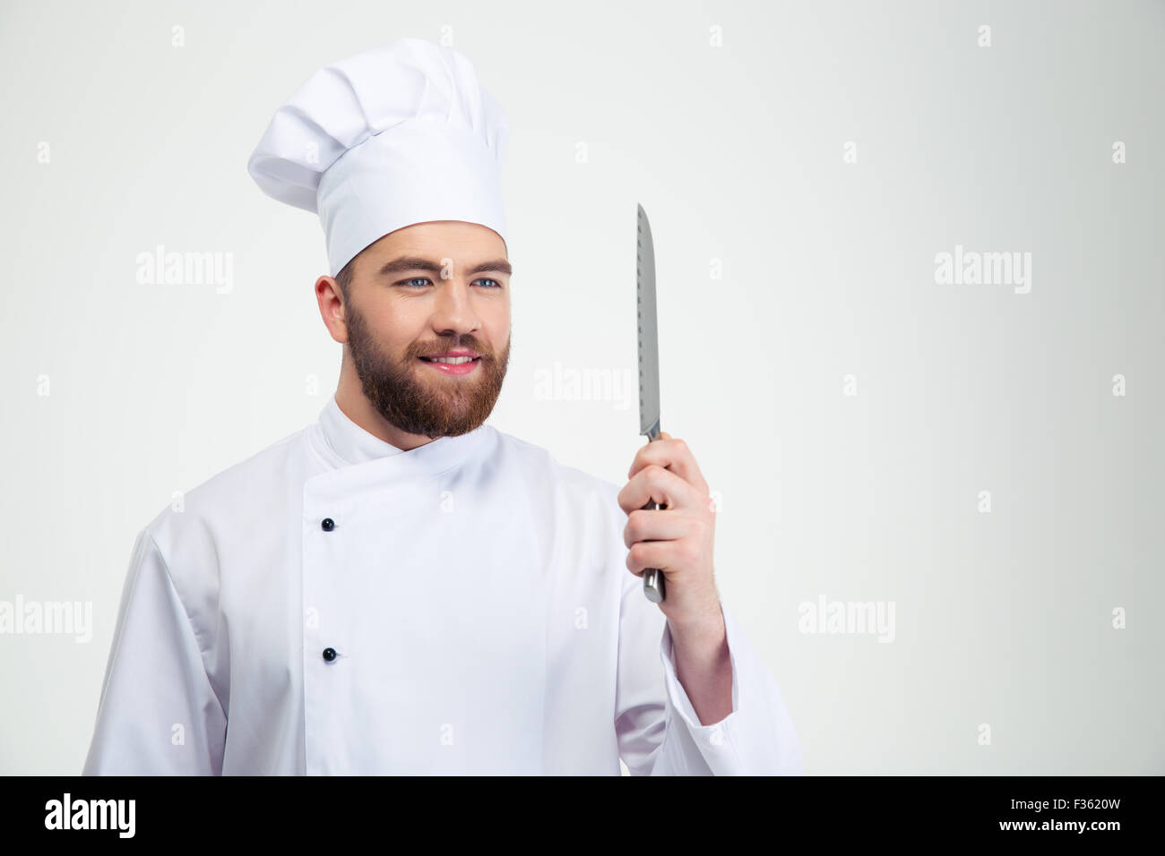 Portrait of a happy chef cook holding knife isolated on a white ...