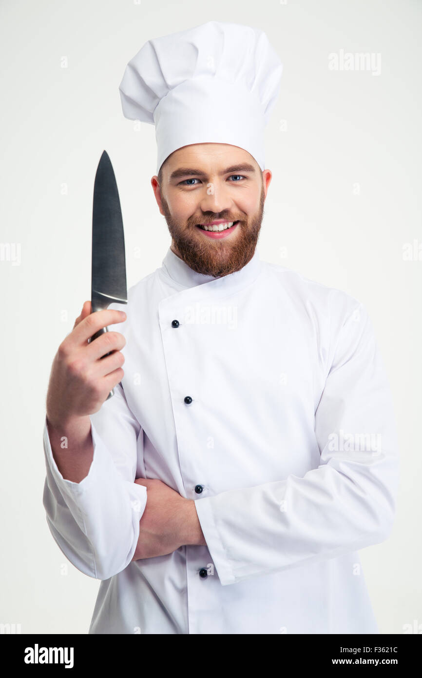 Portrait of a smiling male chef cook showing knife isolated on a white ...
