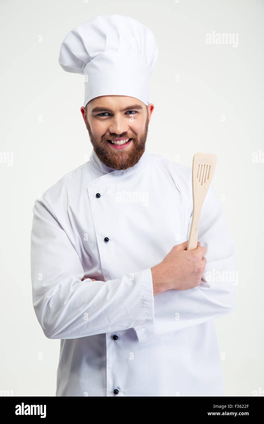 Portrait of a smiling chef cook holding spoon isolated on a white ...