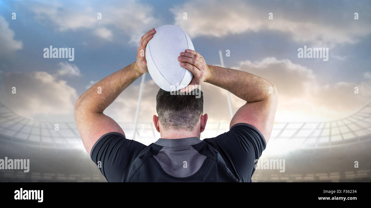 Composite image of tough rugby player throwing ball Stock Photo - Alamy