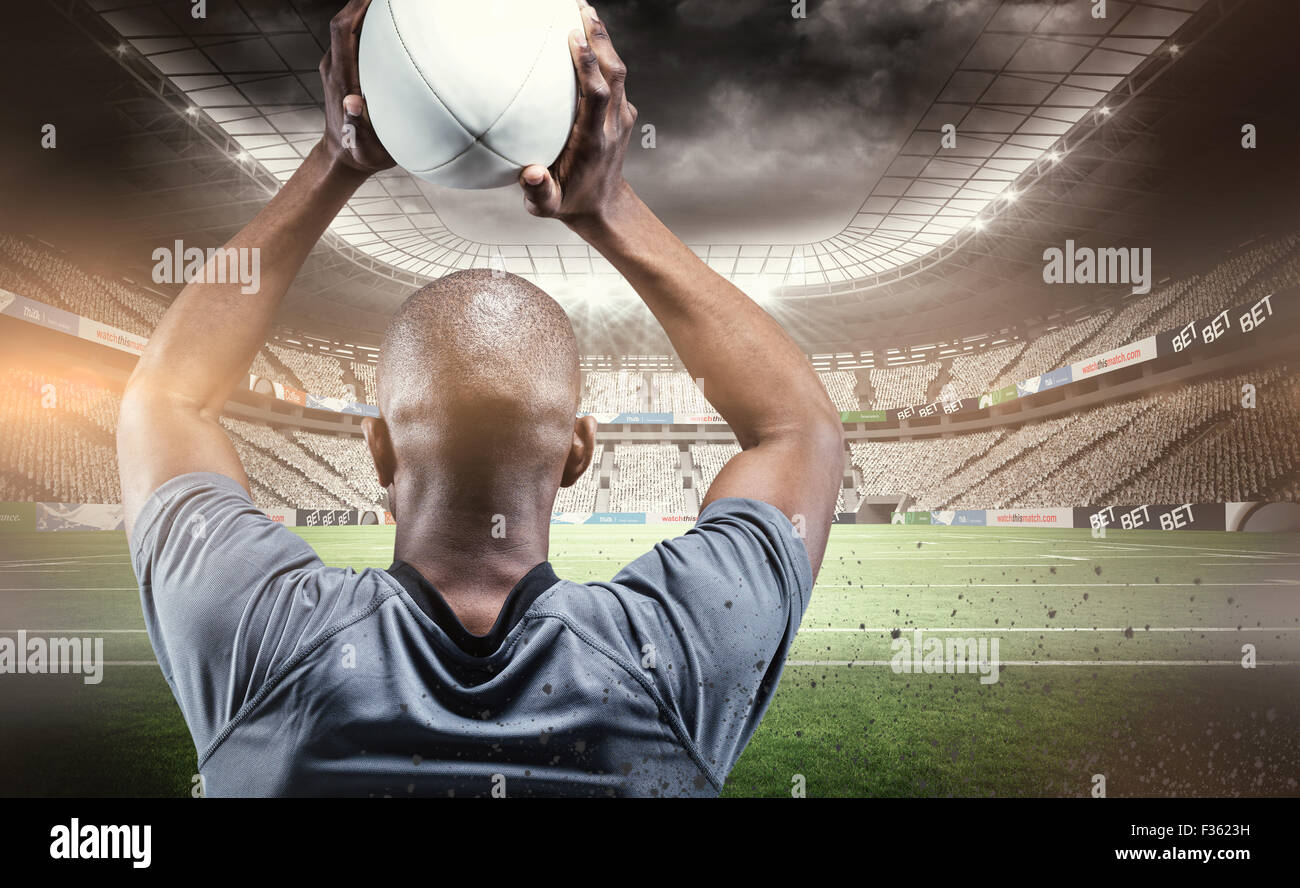 Composite image of sportsman throwing rugby ball Stock Photo - Alamy