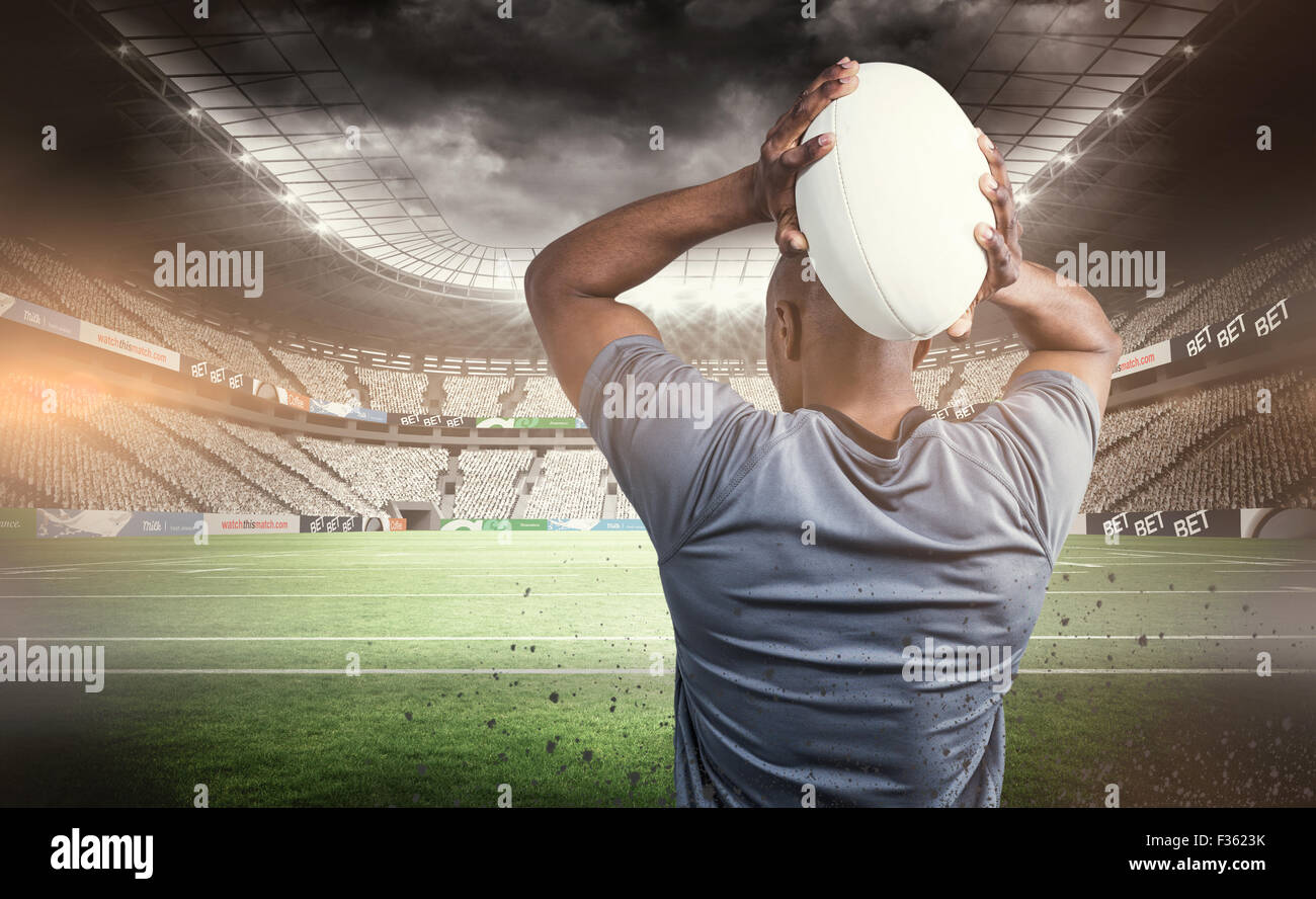 Composite image of rear view of sportsman throwing rugby ball Stock ...