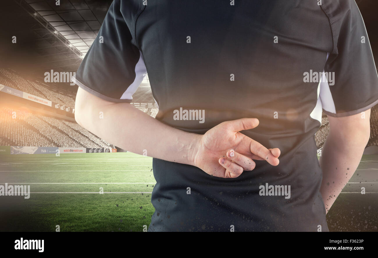 Composite image of back turned rugby player with fingers crossed Stock ...