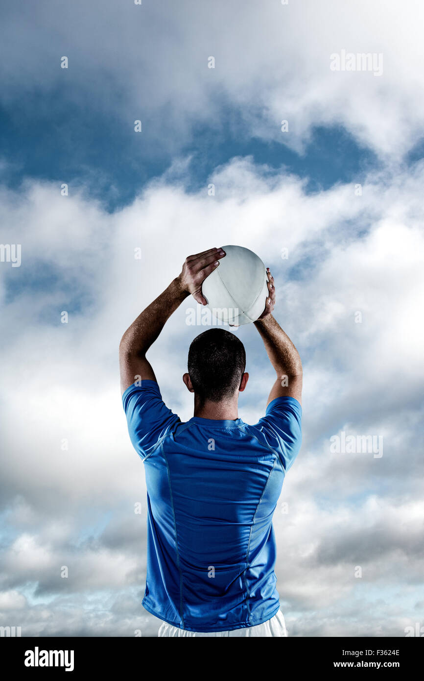 Composite image of rear view of rugby player throwing ball Stock Photo ...