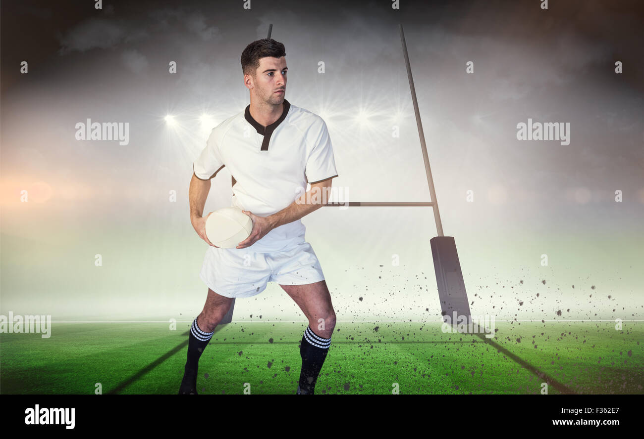 Composite image of rugby player defending with the ball Stock Photo - Alamy