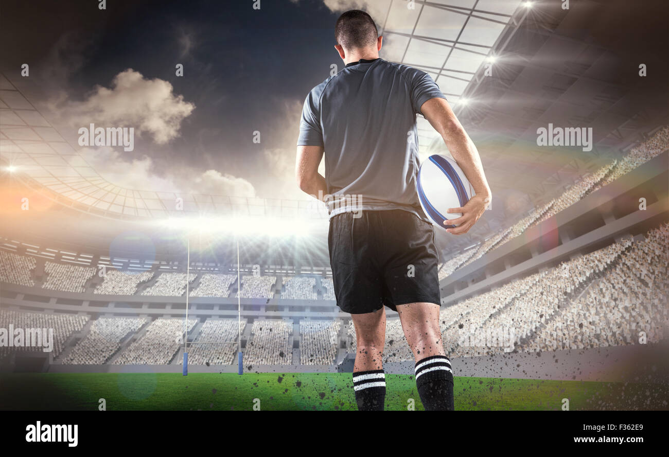 Composite image of rear view of rugby player running with ball Stock ...