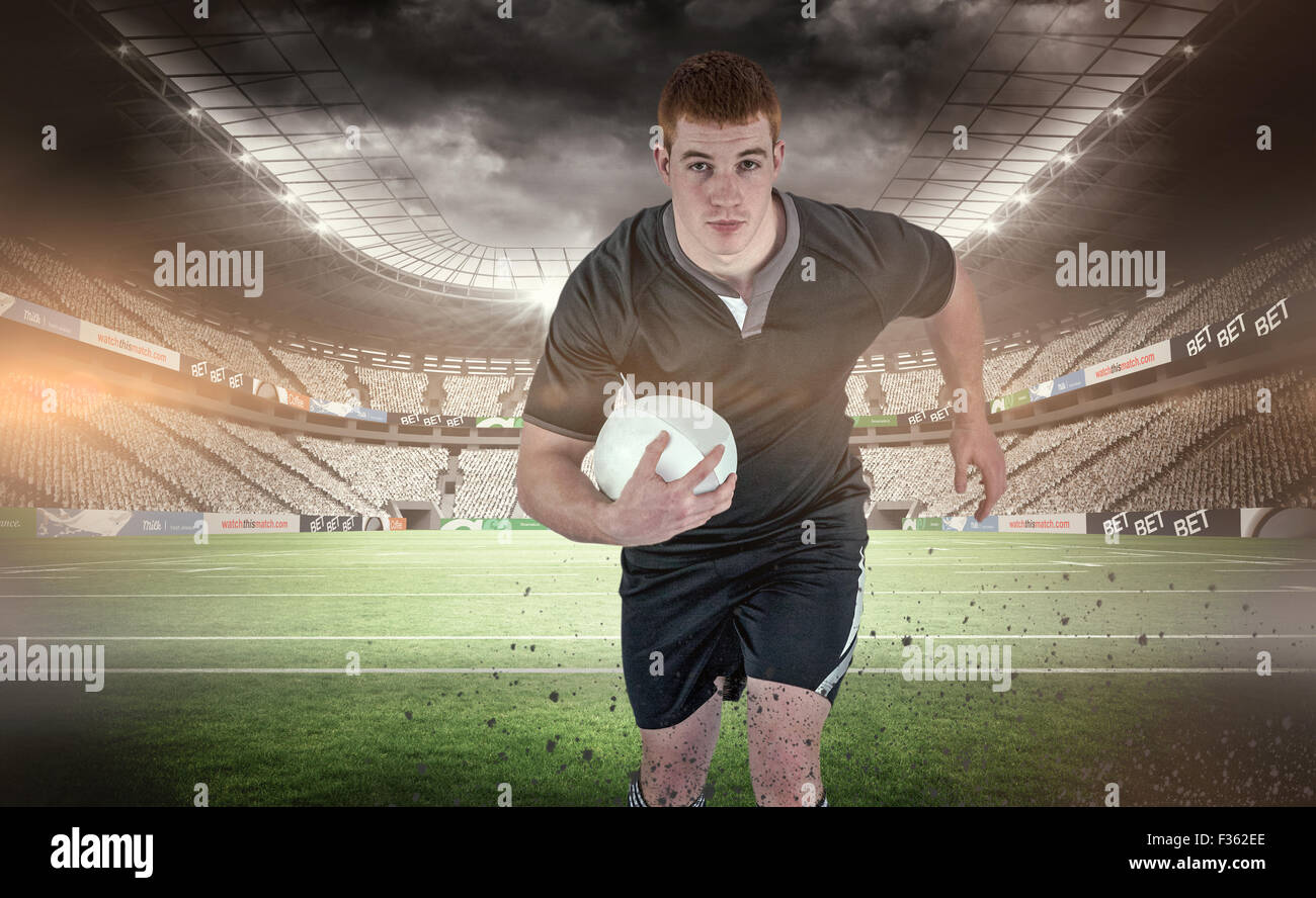 Composite image of rugby player running with a rugby ball Stock Photo ...